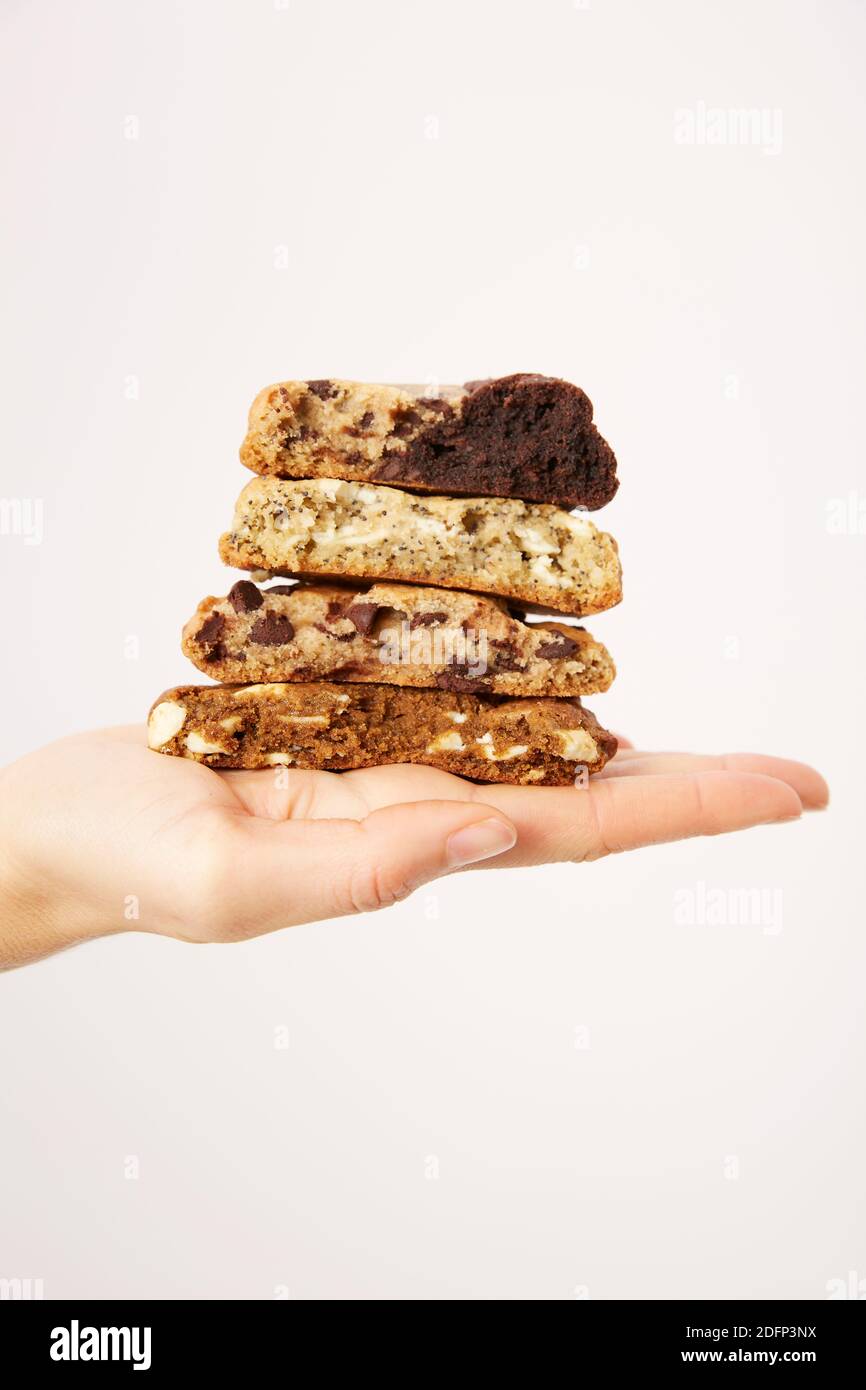 Hand holding cookie stack Stock Photo - Alamy
