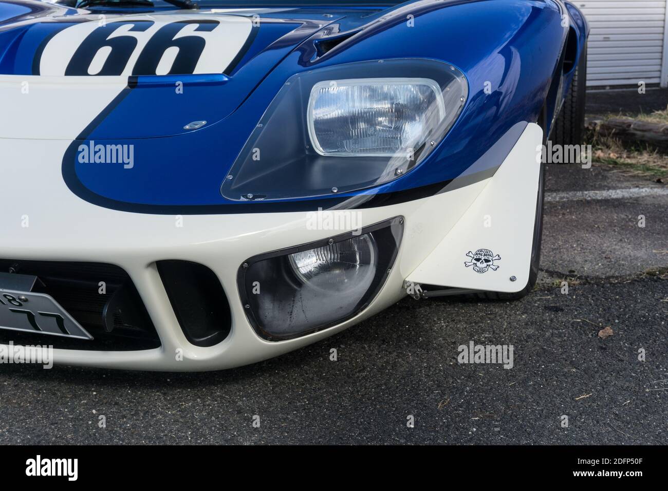 Close up view of the front and side of a metallic blue and white ...