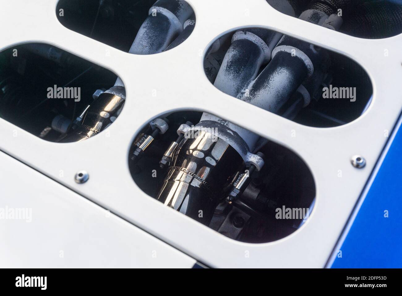 Close up detail of the engine vent and exhaust manifold of a metallic ...