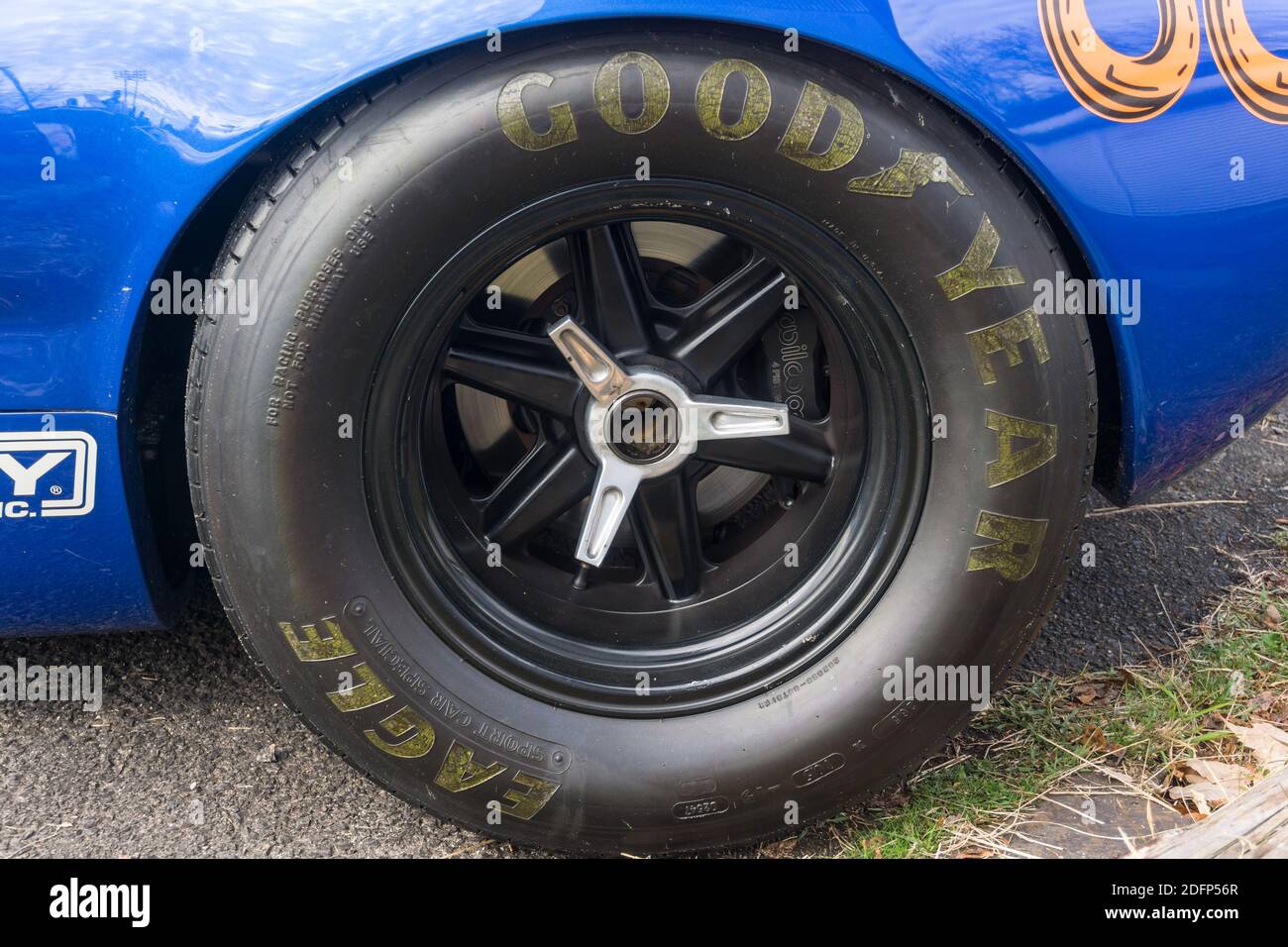Close up detail of a Goodyear Eagle rear tyre and black alloy wheel on ...