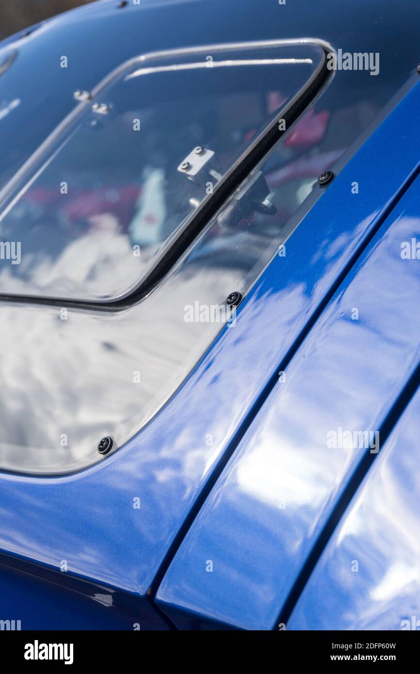 Close up detail of the bodywork and door of a metallic blue and white ...