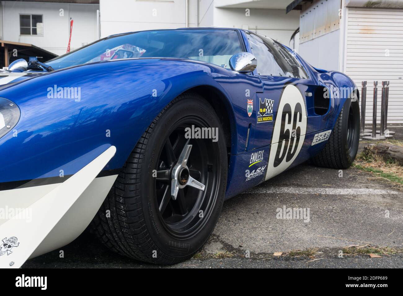 Close up detail of the front wheel and arch of a metallic blue and ...
