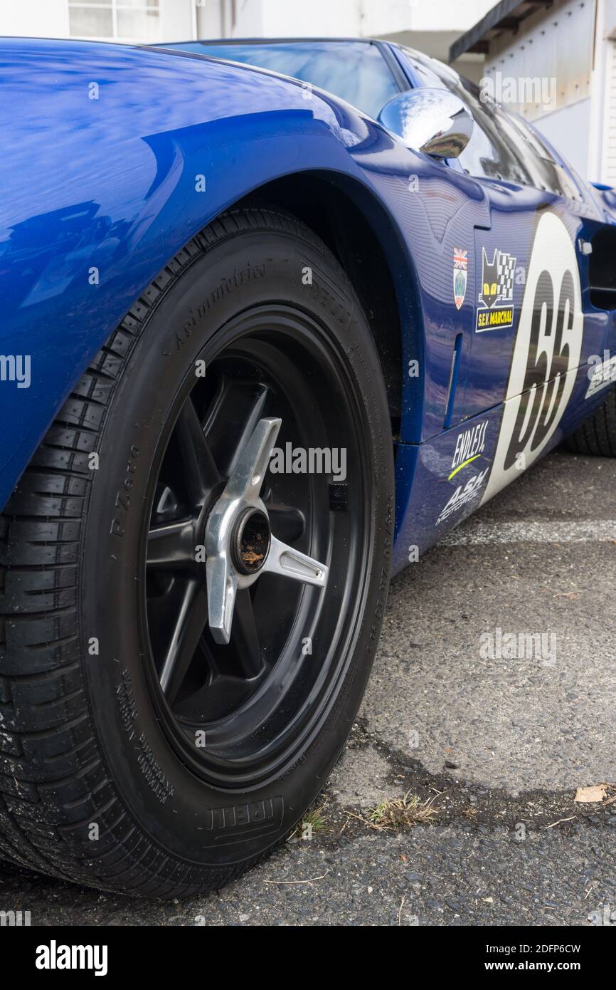Close up detail of the front wheel and arch of a metallic blue and ...