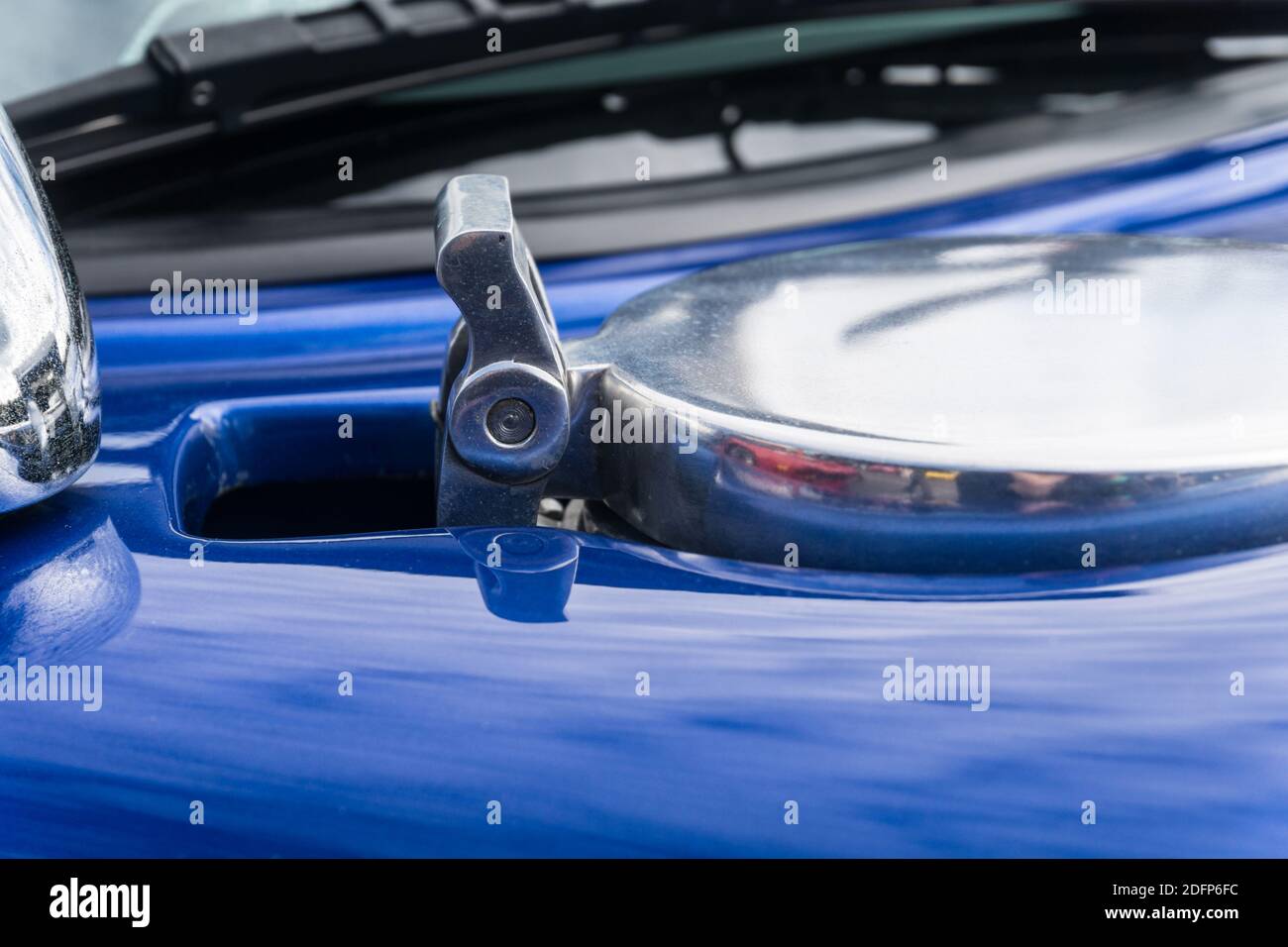 Close up detail of the chrome fuel filler cap on a metallic blue and ...