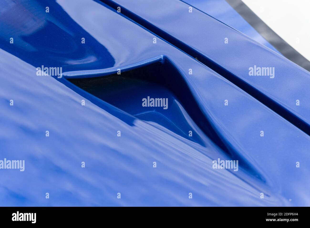 Close up detail of a NACA duct on the bonnet of a metallic blue and ...