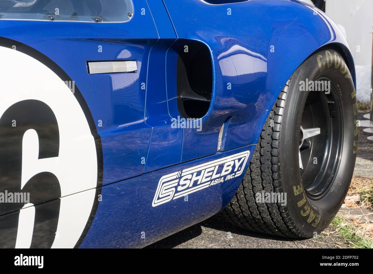 Close up detail of the rear wheel, bodywork and arch of a metallic blue ...