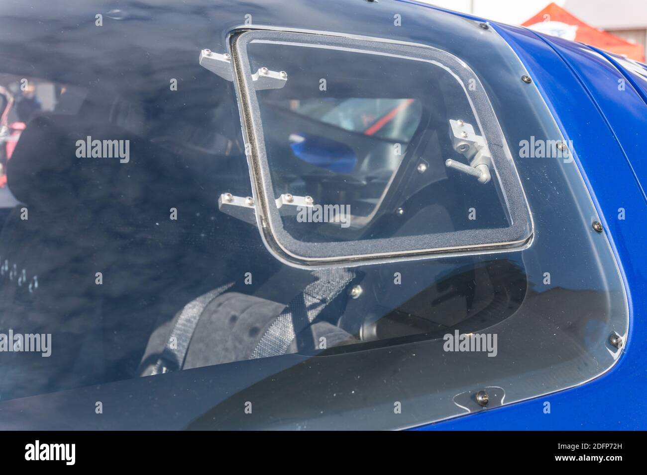 Close up detail of the perspex drivers door window on a metallic blue ...