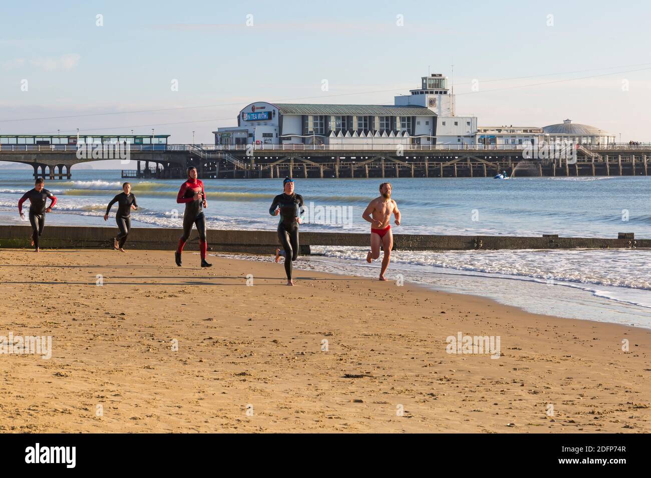 Bournemouth lifeguards running along the seashore hi-res stock ...