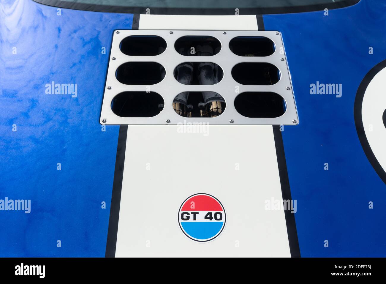 Close up detail of a vent over the exhaust manifold of a metallic blue ...