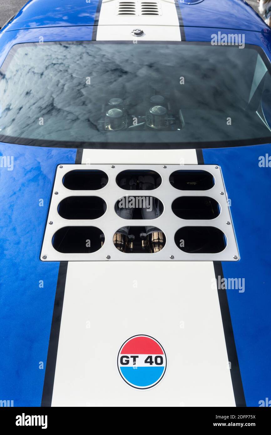 Close up detail of a vent over the exhaust manifold of a metallic blue ...