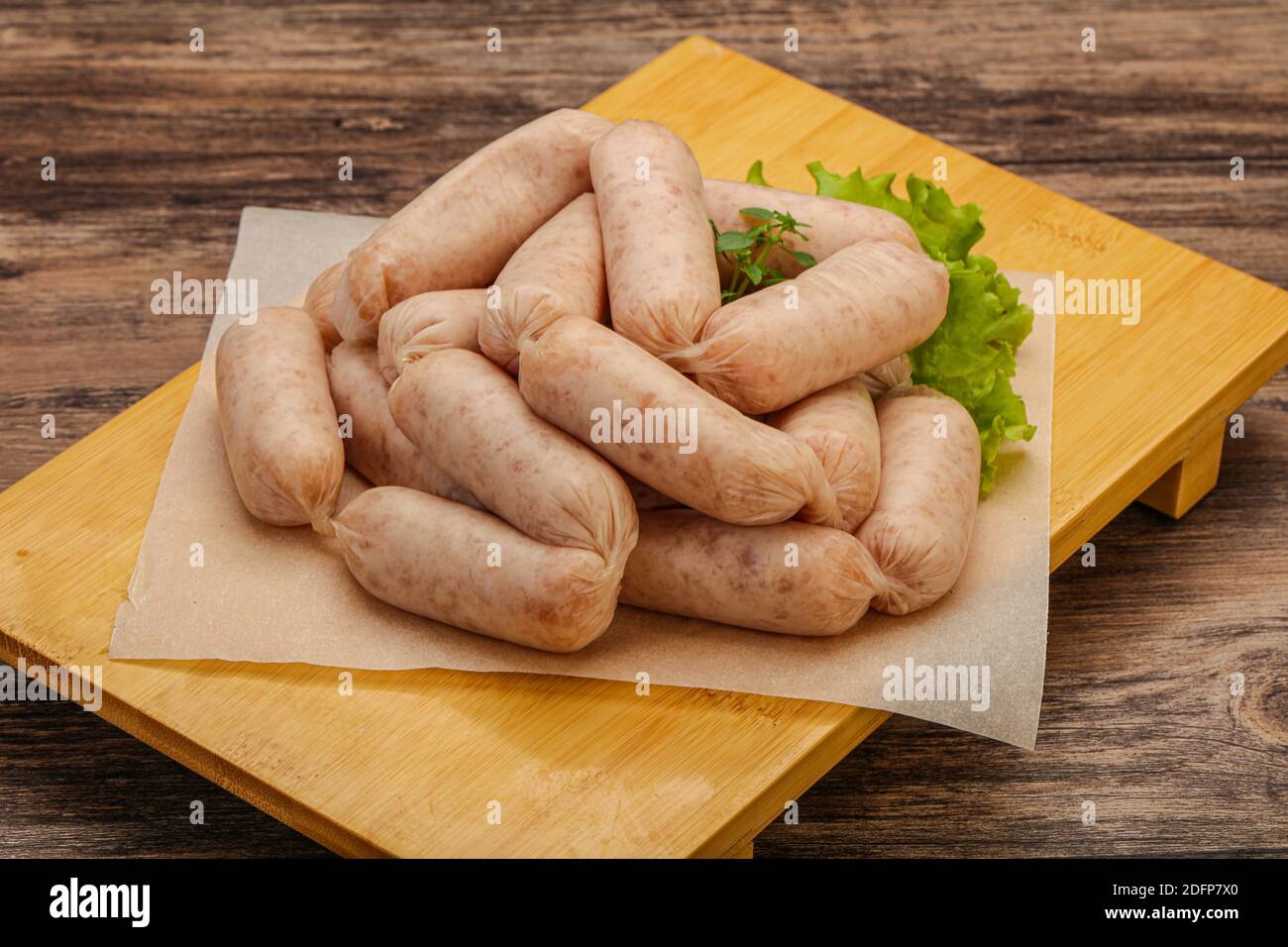 Raw natural chicken baby sausages for roast Stock Photo - Alamy