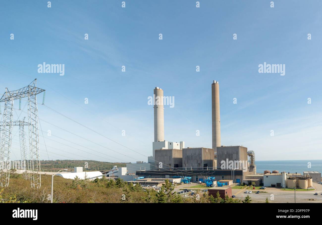 Power generating station. Transmission tower on the right. Large smoke ...