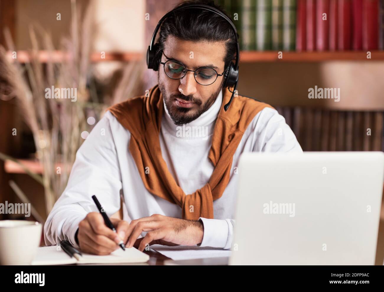 Indian Guy Taking Notes Learning At Laptop Online At Home Stock Photo ...