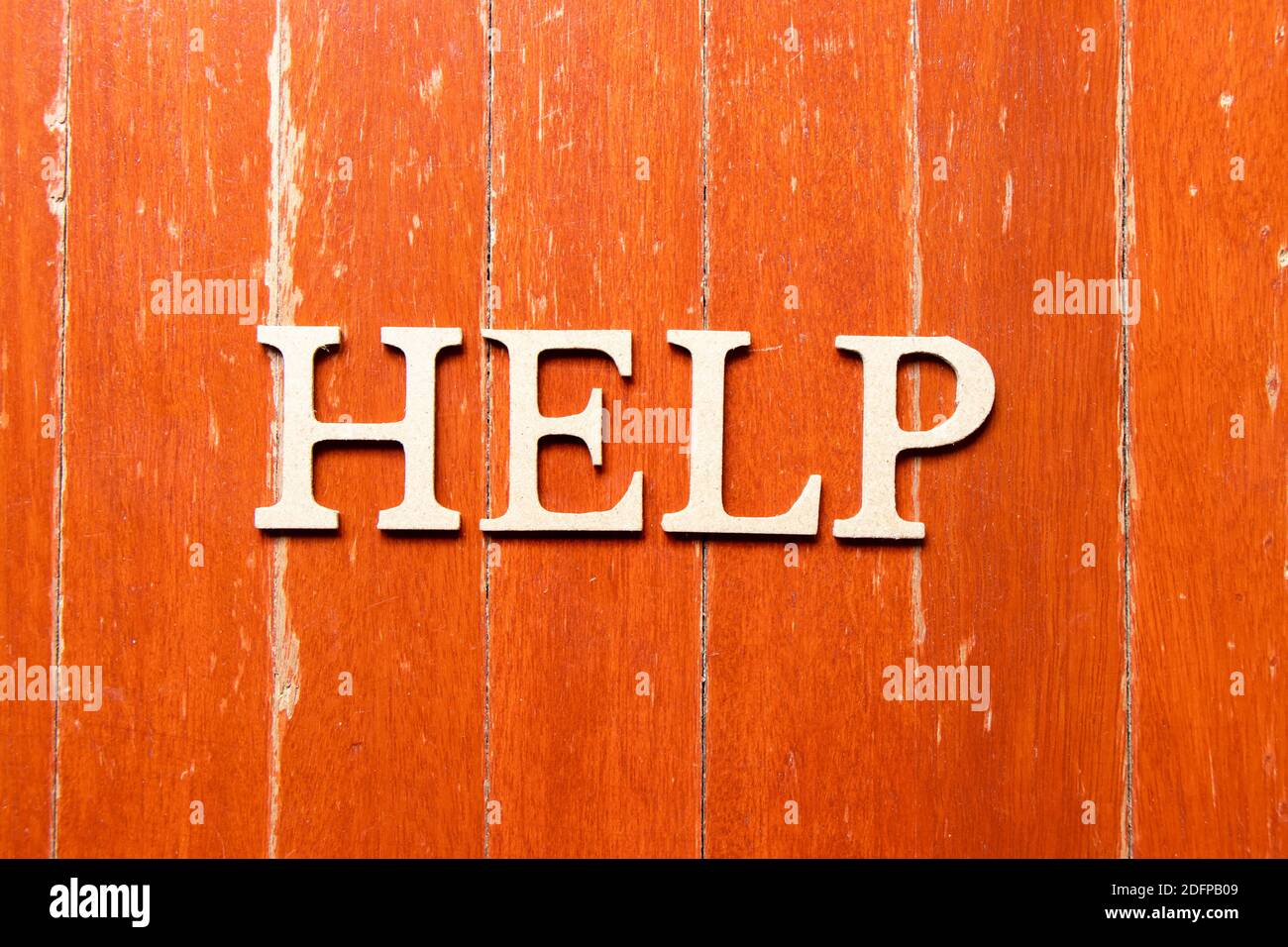 Alphabet letter in word help on old red color wood plate background ...