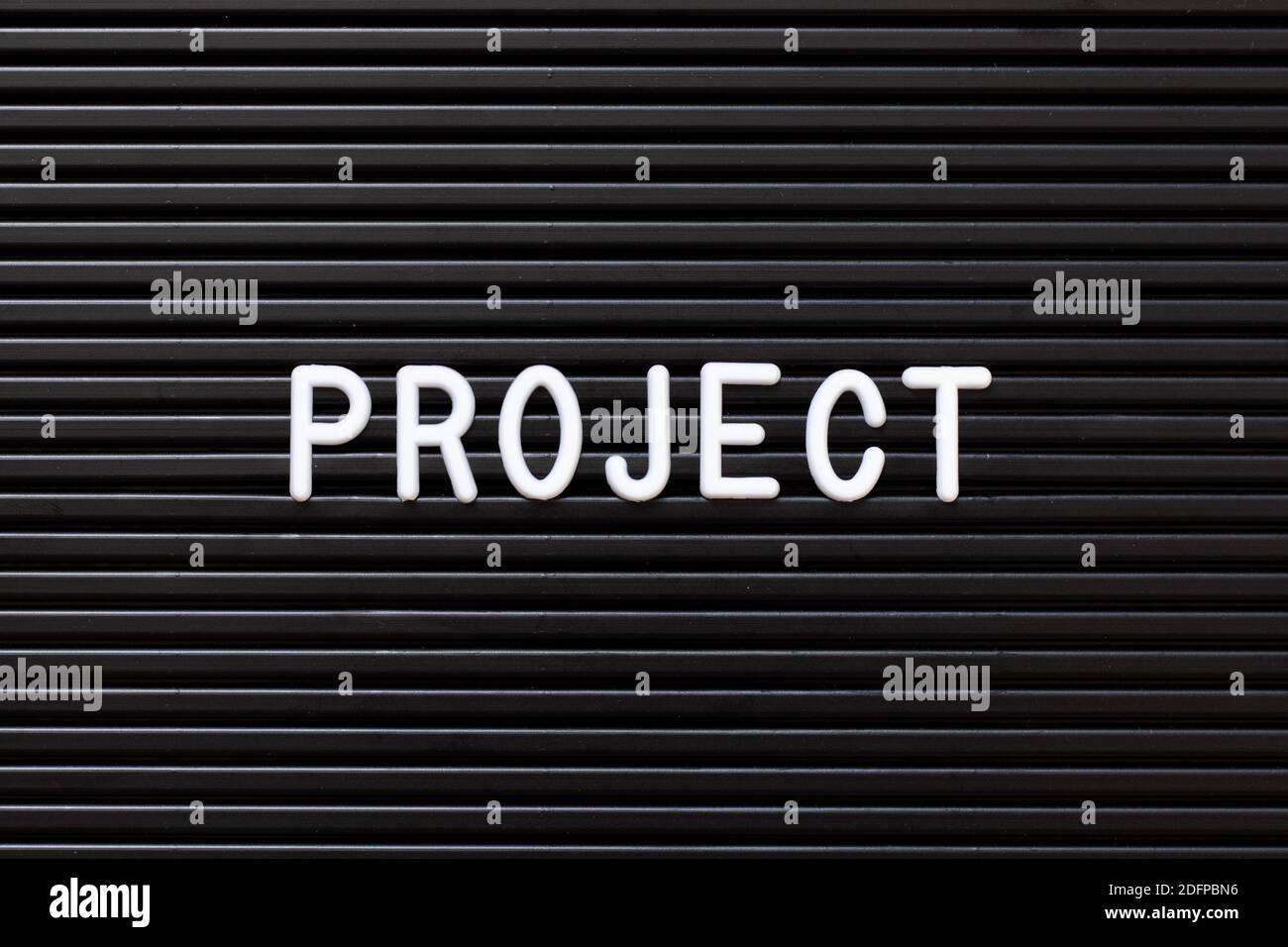 White alphabet in word project on black color felt letter board ...