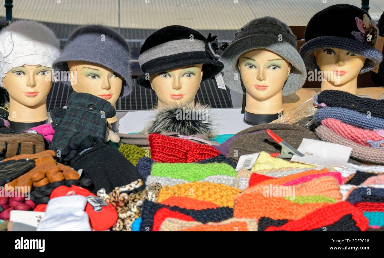 european sale stall with woolen caps on the heads of window dolls from ...