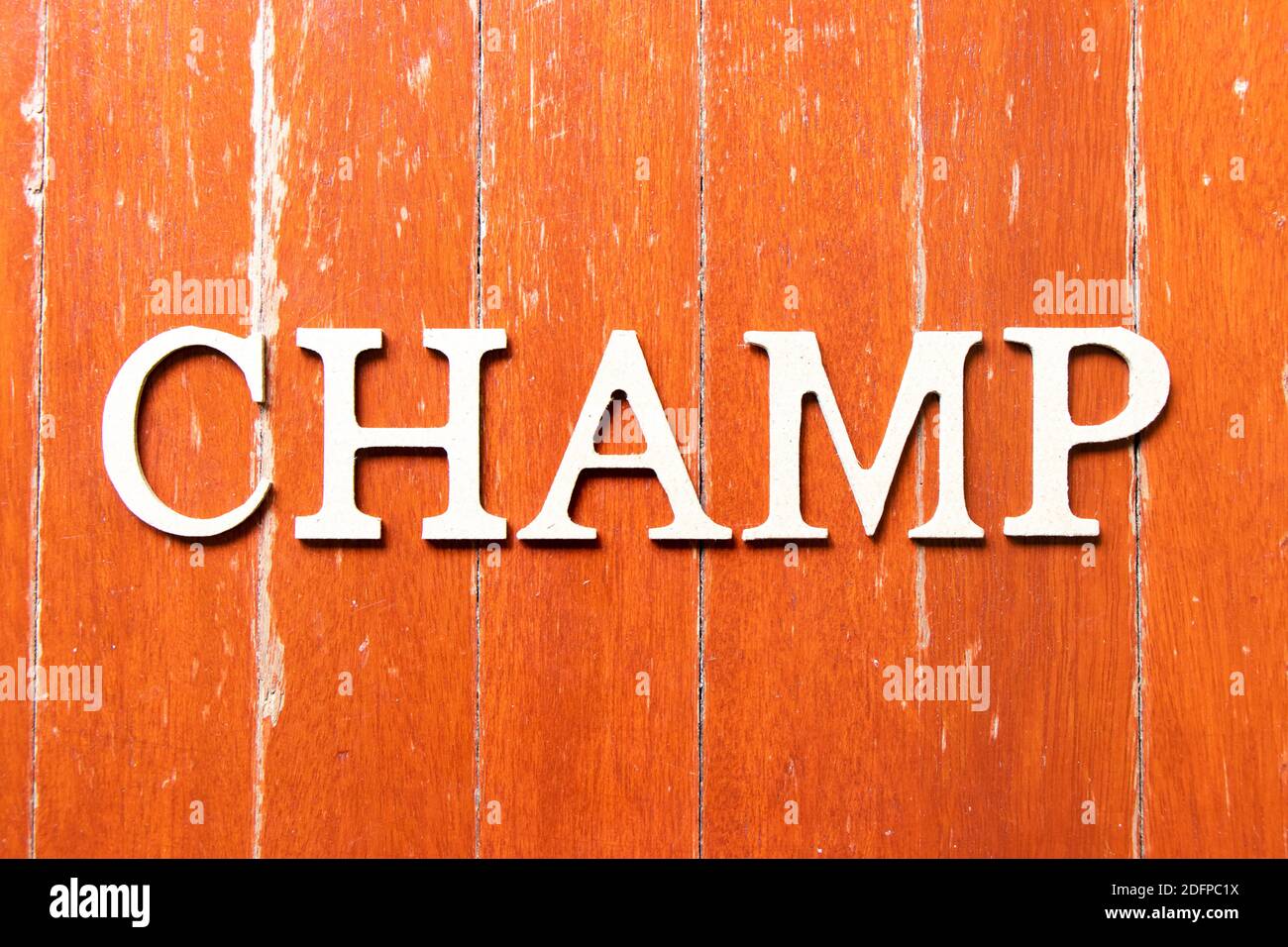 Alphabet letter in word champ on old red color wood plate background ...