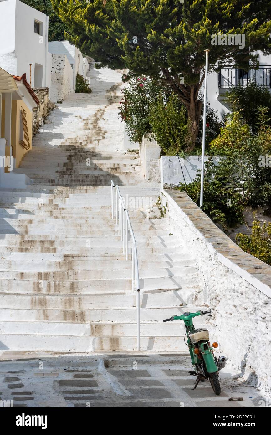 A vertical shot of a moped at the bottom of a staircase in the Greek ...