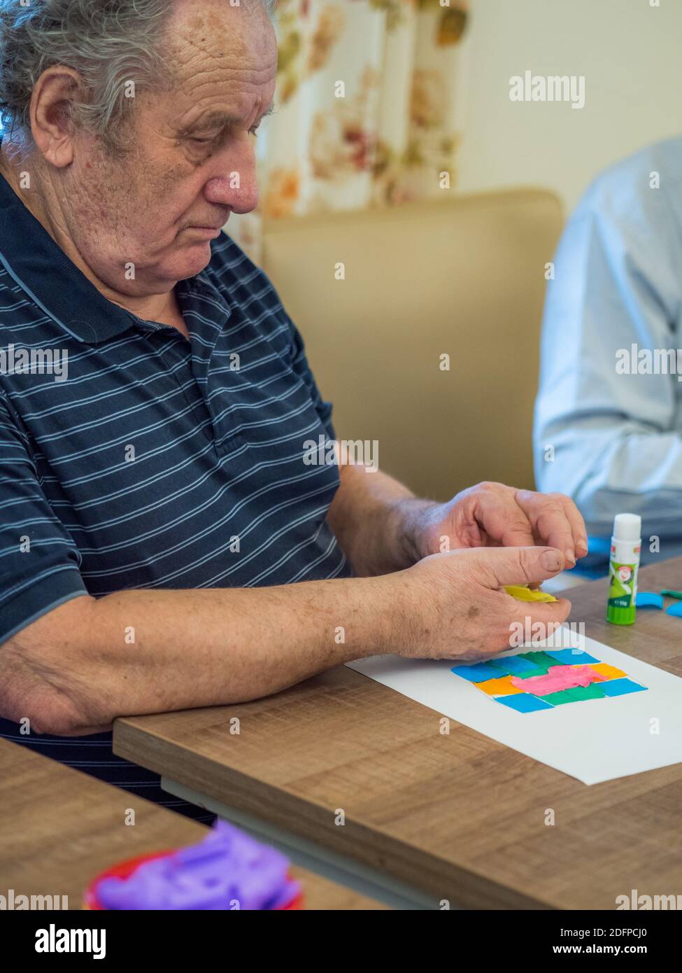 Senior activity concept. Exercises by cutting, gluing and creating ...