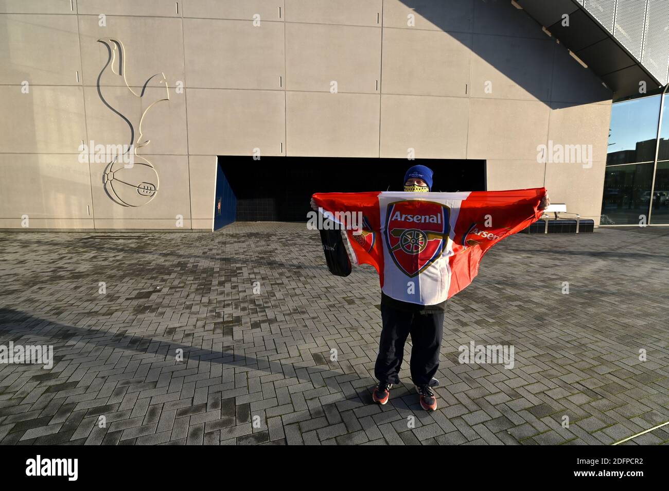 A lone Arsenal fan holds up a flag outside the stadium before the ...