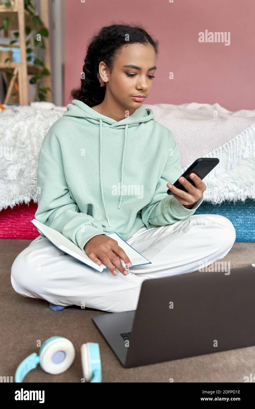 African american teen girl distance learning online using laptop and ...