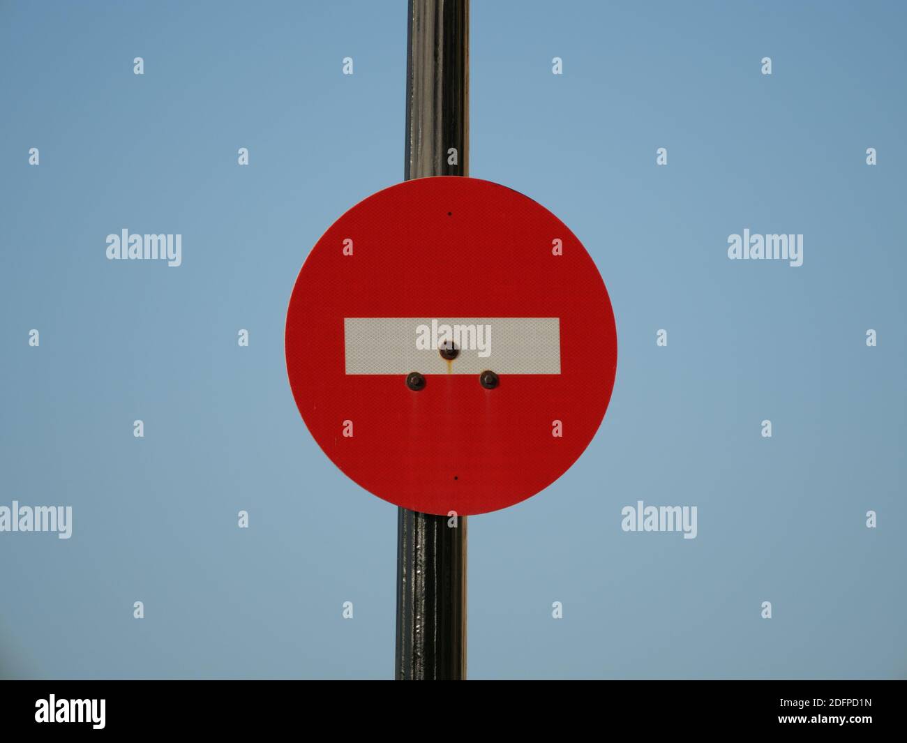 A red 'do not enter' sign against blue background Stock Photo - Alamy