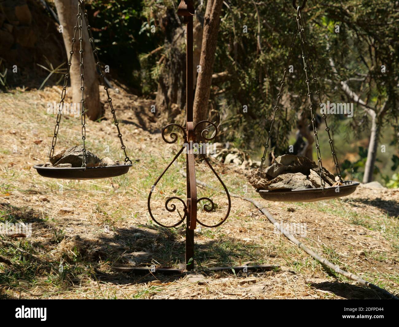 An old rusty metallic scale weighing stones Stock Photo - Alamy