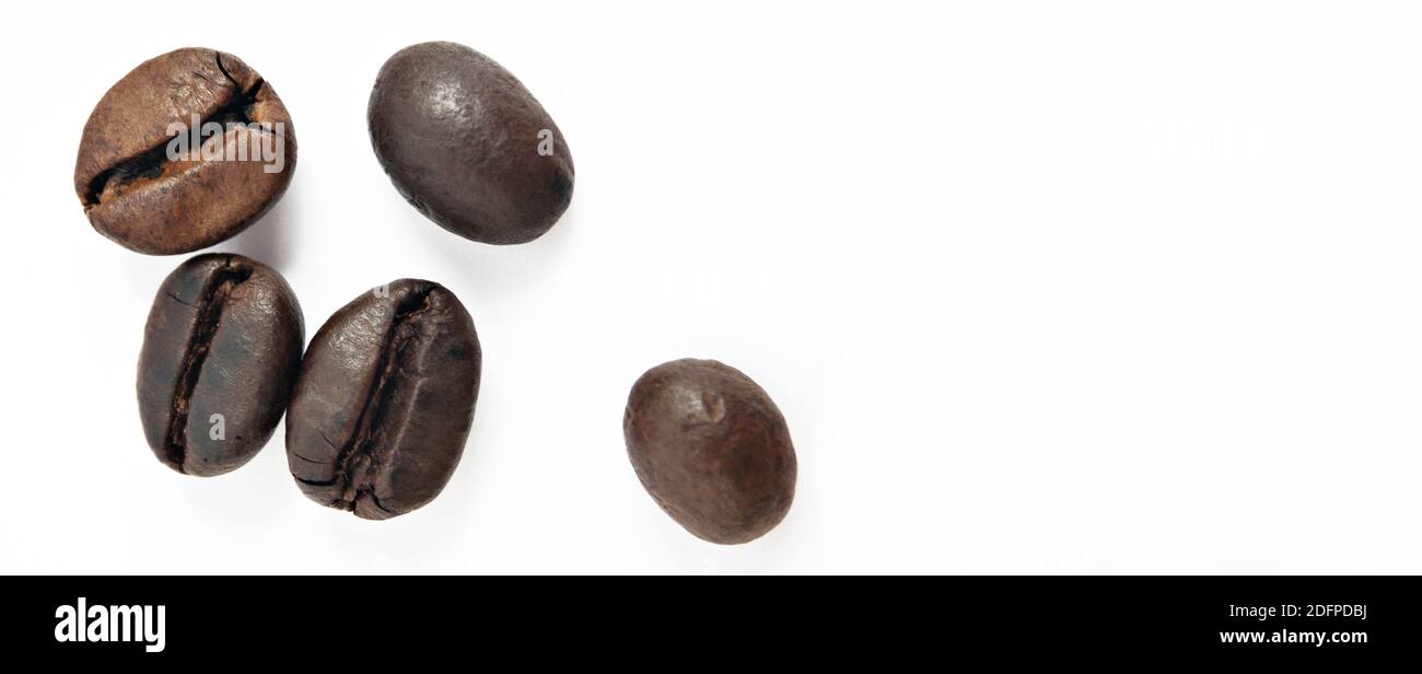 Shiny freshly roasted coffee beans on a white background. Isolated ...
