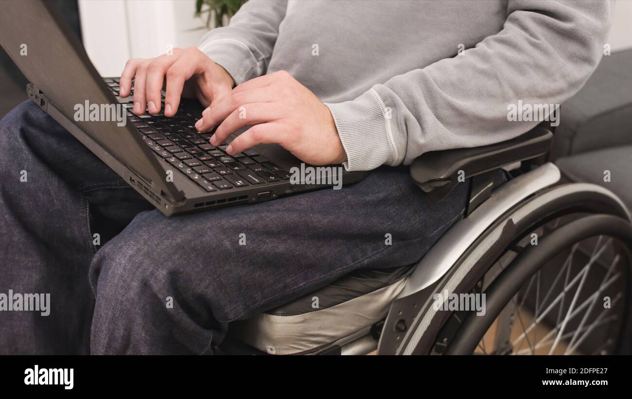 Disabled man using computer typing hi-res stock photography and images ...