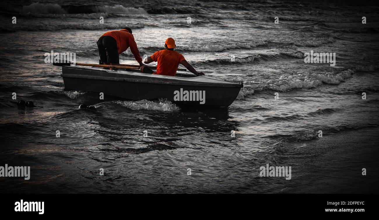 Beach lifeguards rowing boat hi-res stock photography and images - Alamy