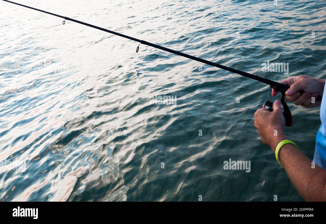 angler with his ultra-light spinning rod Stock Photo - Alamy