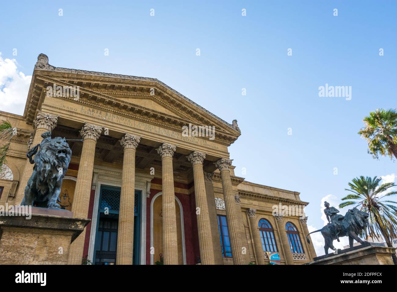 A low angle shot of the Massimo Theater under the sunlight and a blue ...