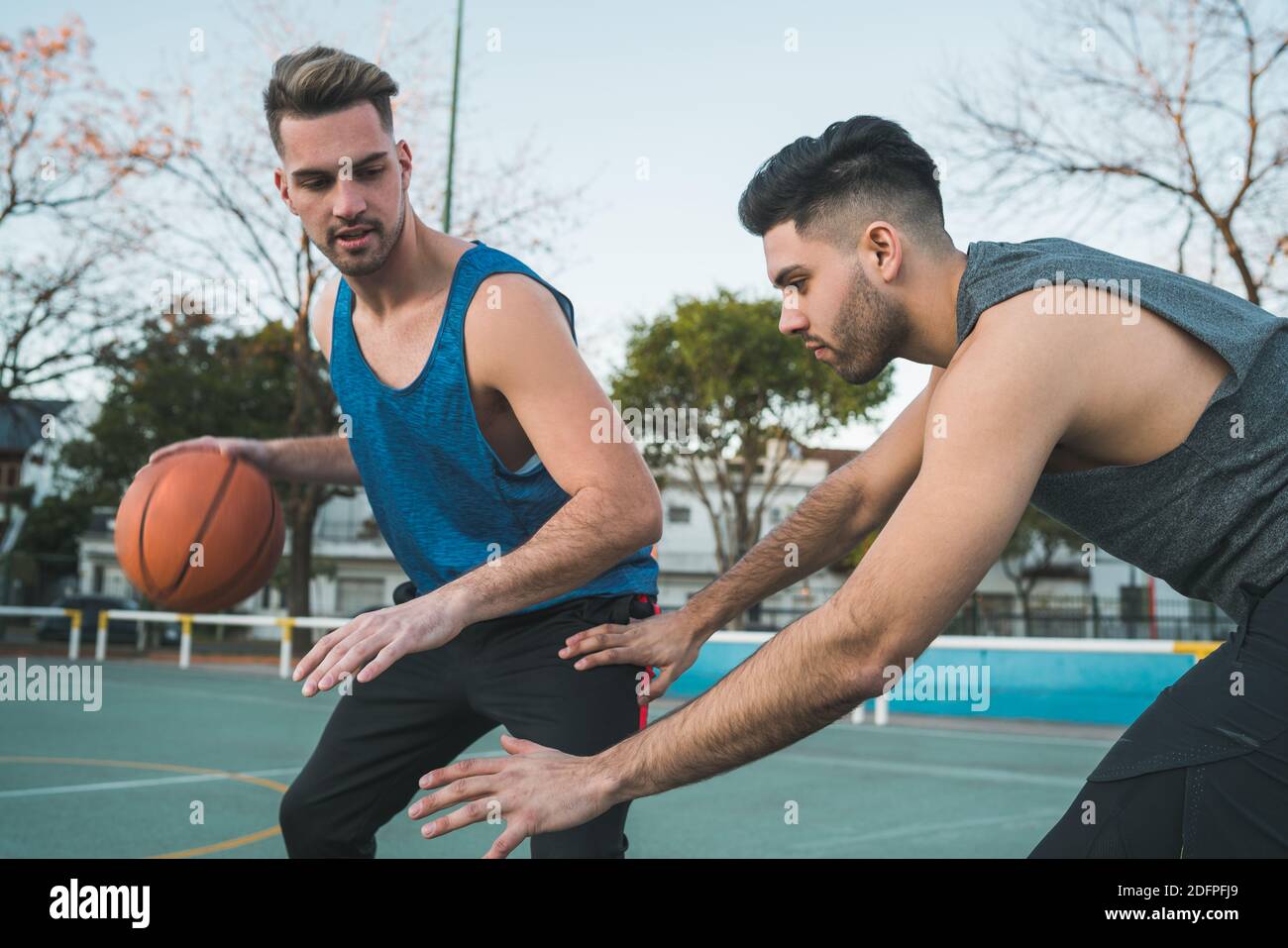Young basketball players playing one-on-one Stock Photo - Alamy