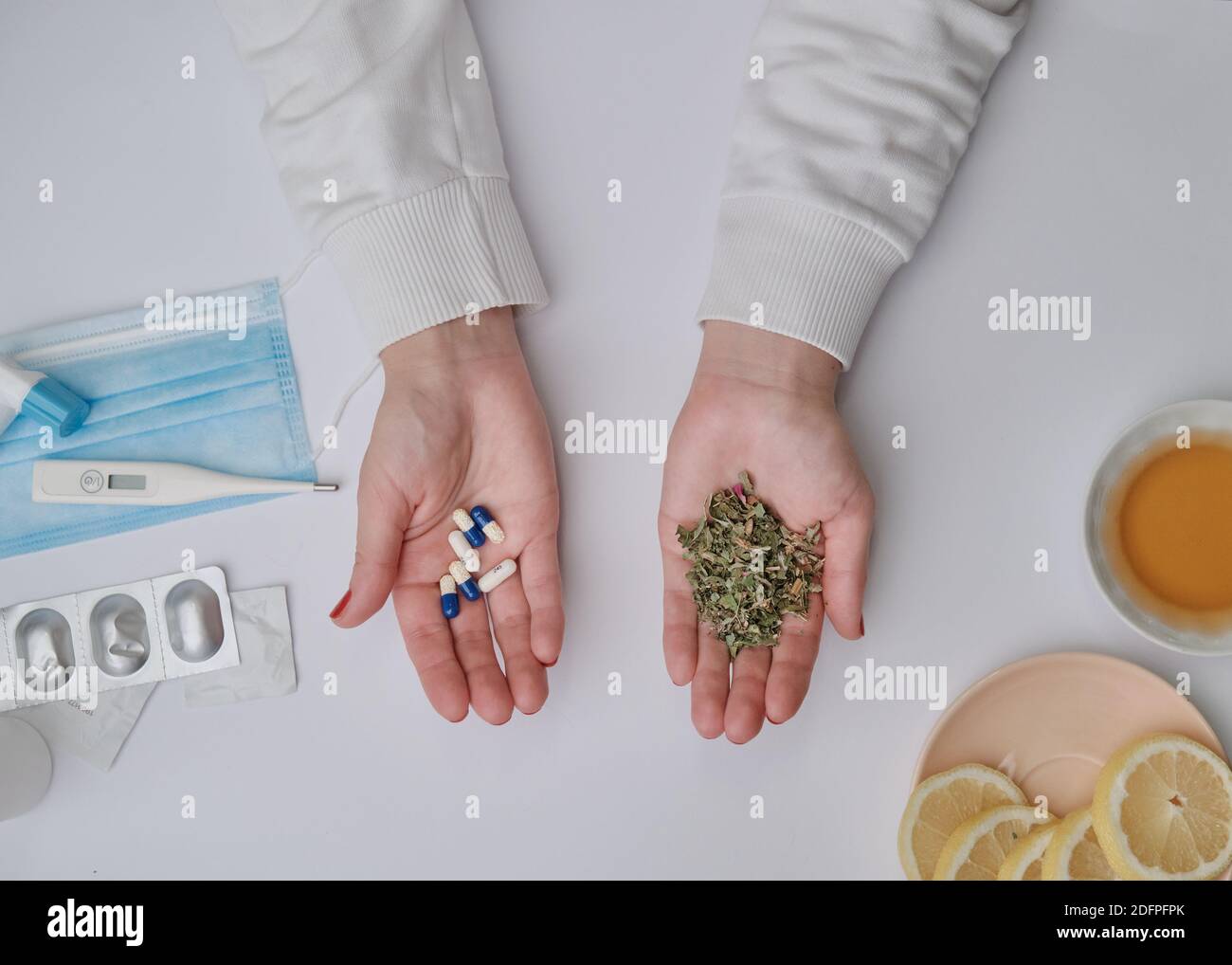 Medicine pills or herbs concept. Natural herbs. Two hands as a scale ...