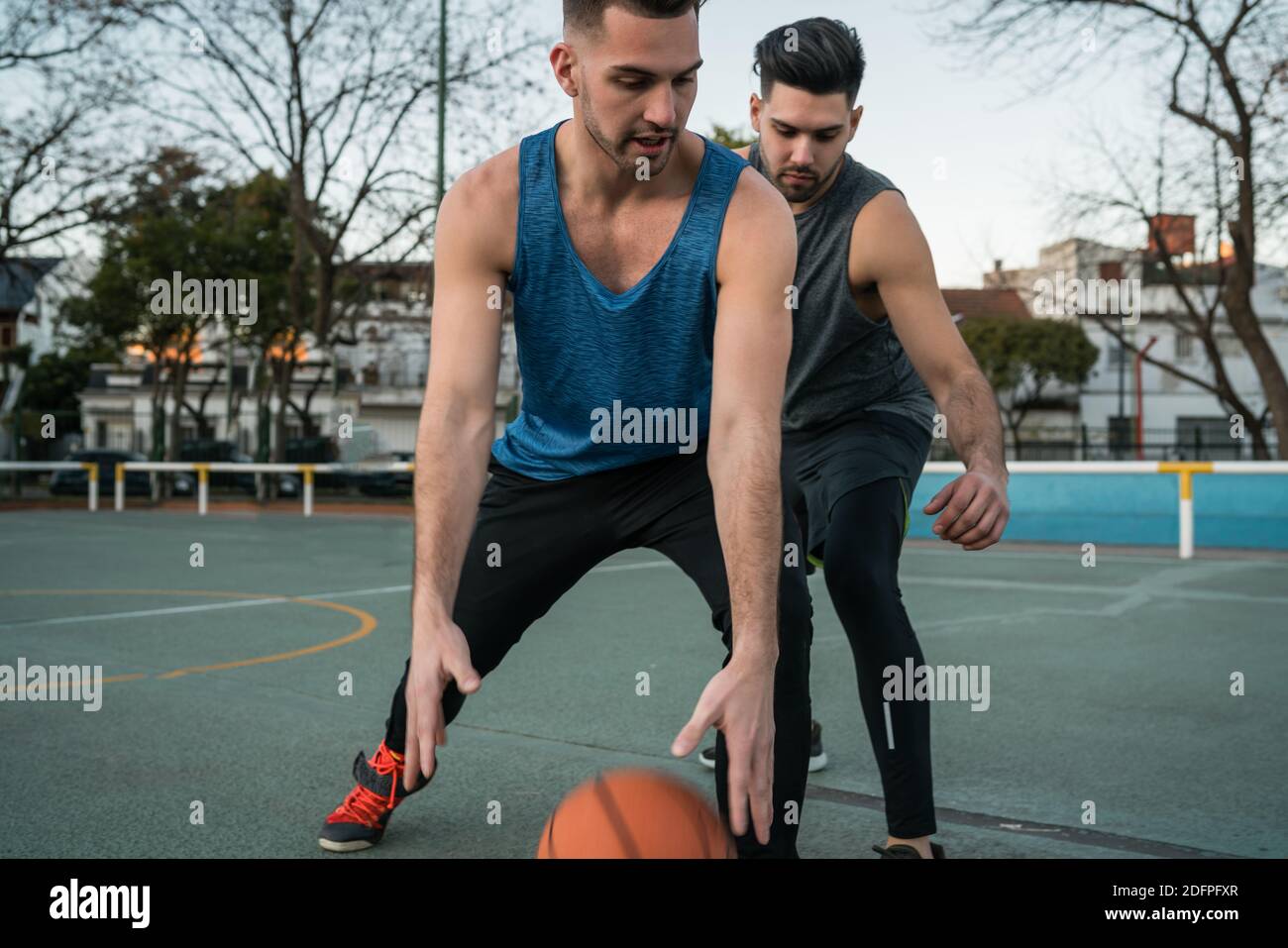 Young basketball players playing one-on-one Stock Photo - Alamy