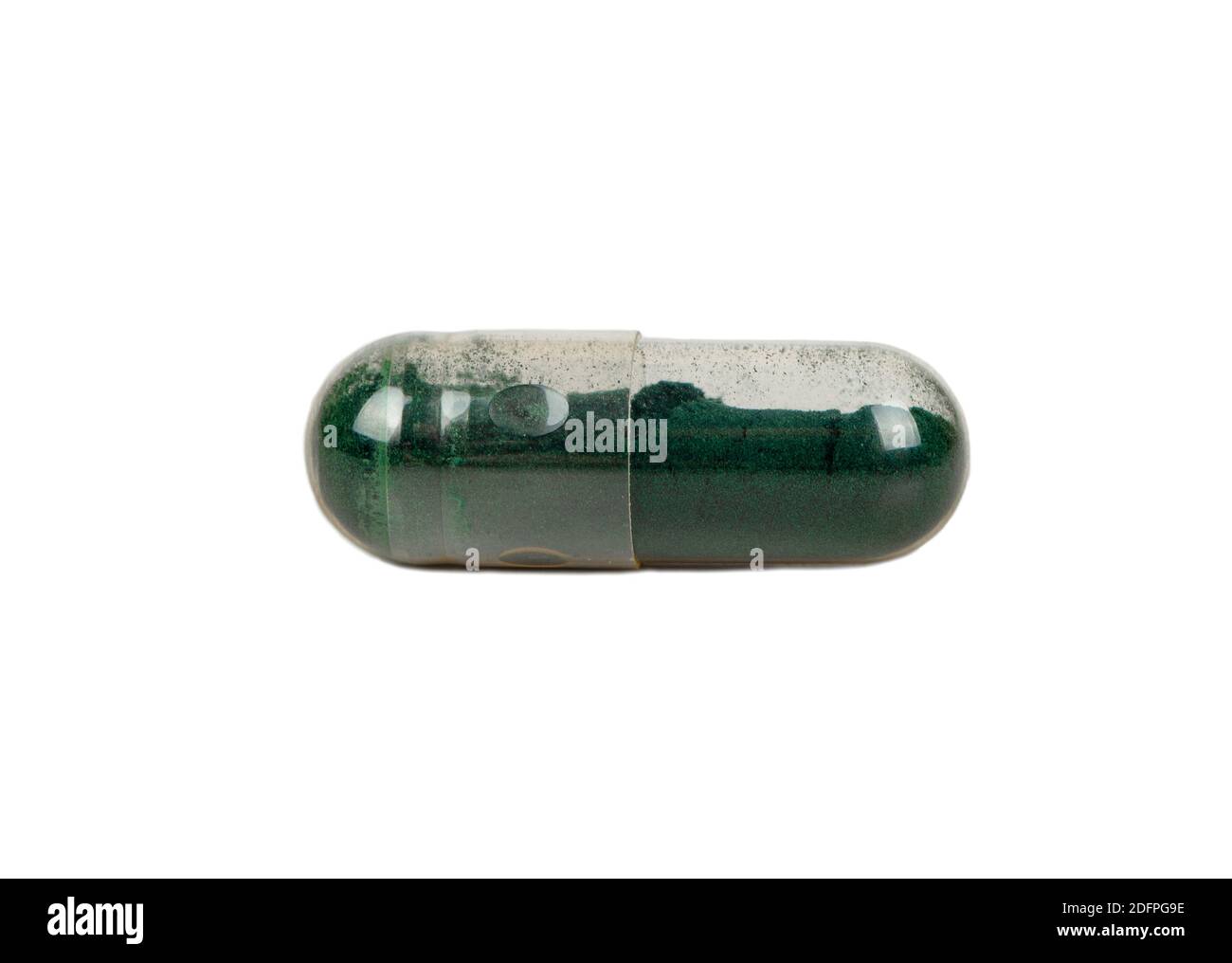 Transparent capsule with medicinal green grass isolated on a white ...