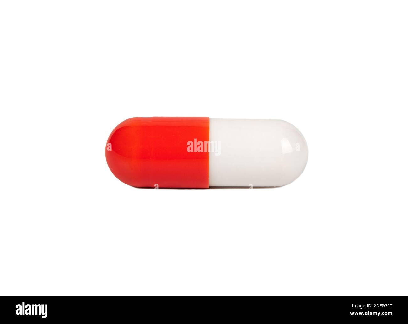 Red and white capsule isolated on a white background Stock Photo - Alamy