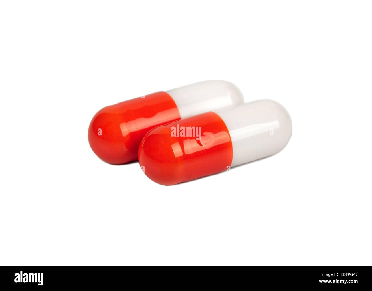 Two red and white capsules isolated on a white background Stock Photo ...