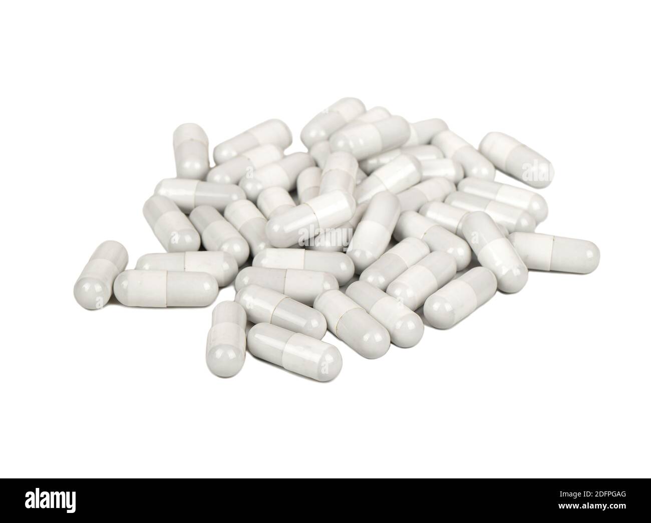Pile of scattered gray capsules on a white background Stock Photo - Alamy