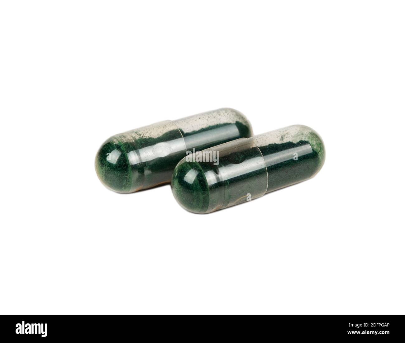 Two green capsules isolated on a white background Stock Photo - Alamy