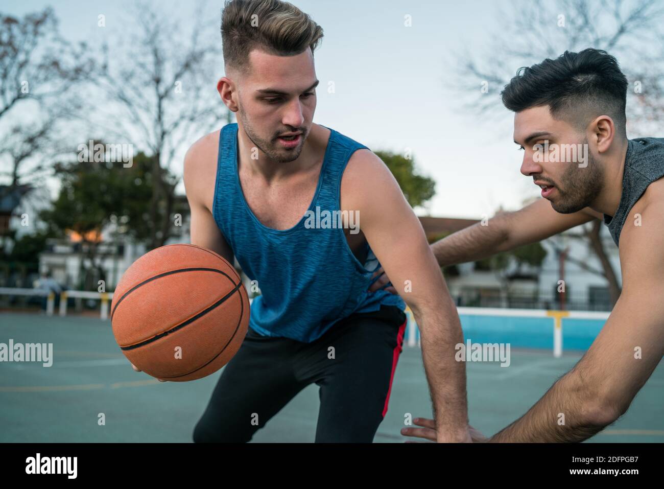 Young basketball players playing one-on-one Stock Photo - Alamy