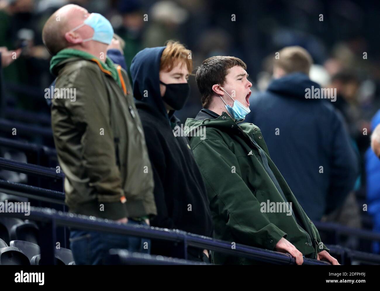 Fans cheer from the stands as they watch the players warm up on the ...