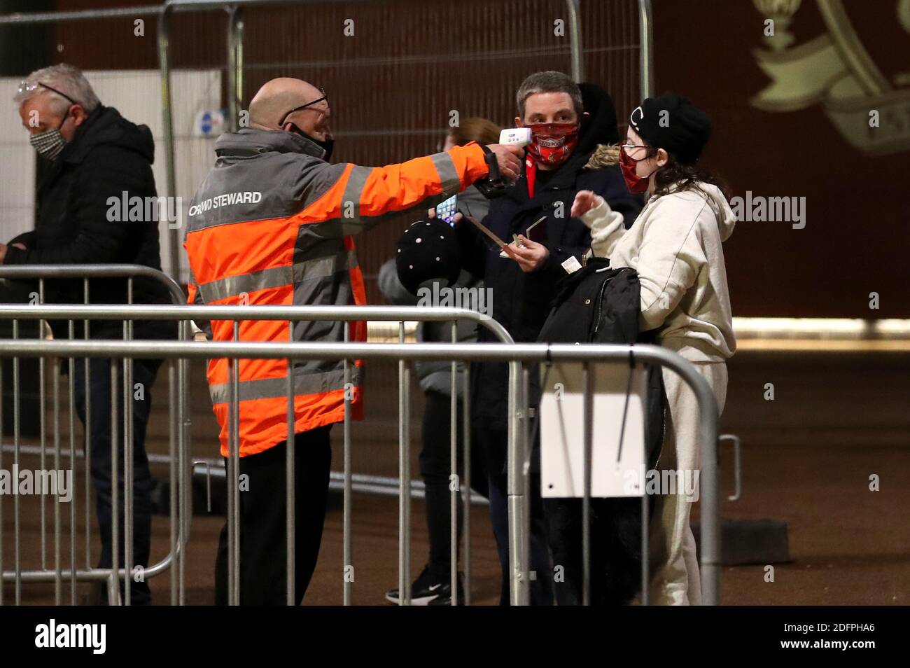 Liverpool fans have their temperature checked as they arrive for the ...