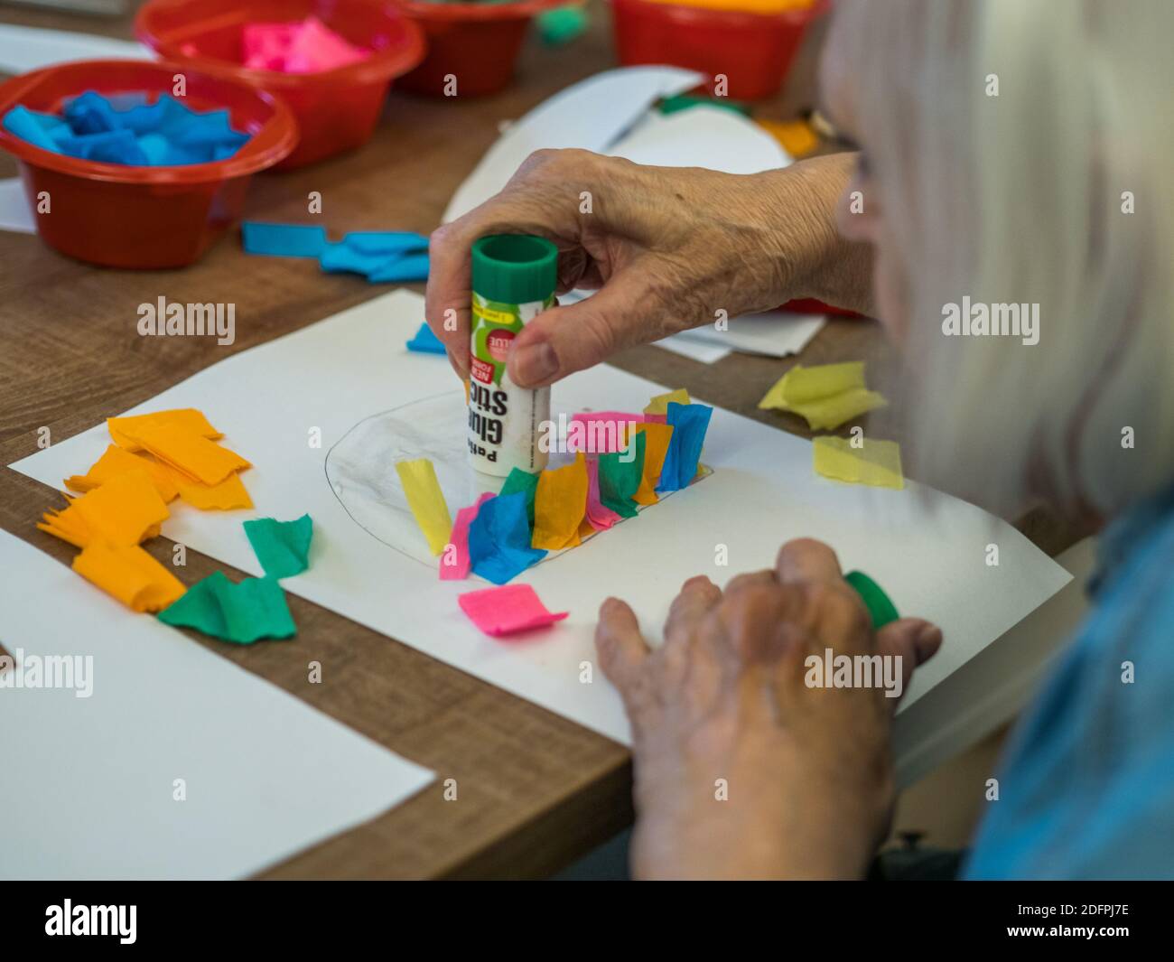 Senior activity concept. Exercises by cutting, gluing and creating ...