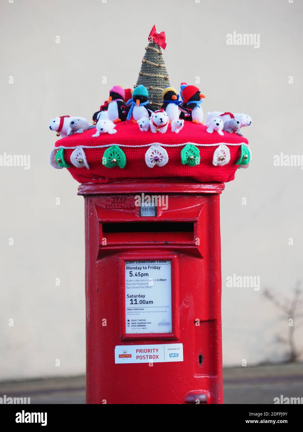 Faversham, Kent, UK. 6th December, 2020. Knitted tops for post boxes ...