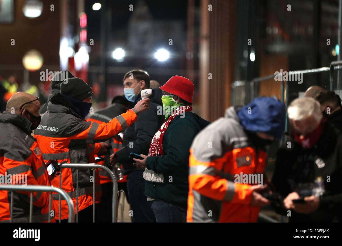 Liverpool fans have their temperature checked as they arrive for the ...