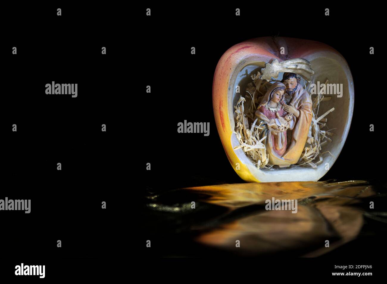 Nativity scene in the apple. Still life of the holy family statuette ...