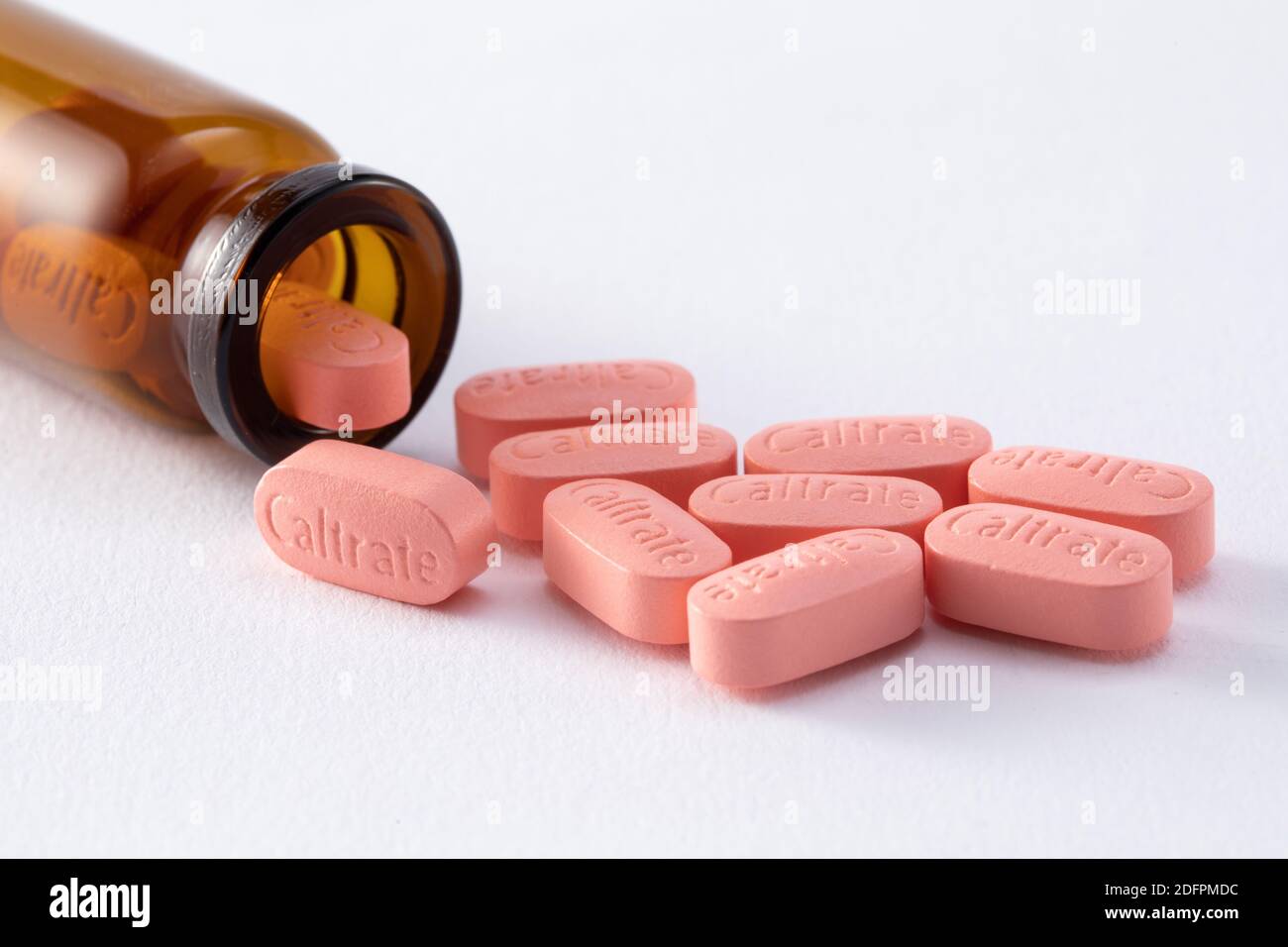 pink medical pills of Caltrate with a transparent bottle isolated on a ...
