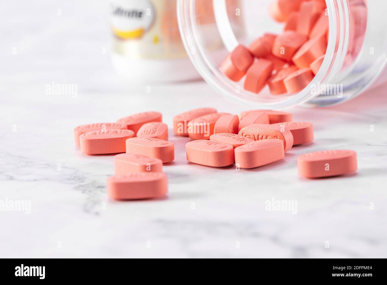 Pink medical pills of Caltrate with a transparent bottle isolated on a ...