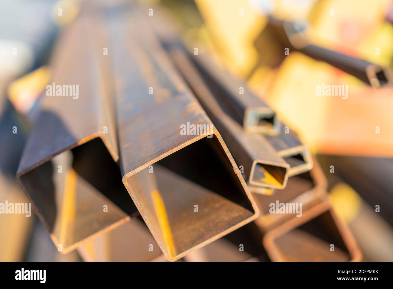 stack of steel pipe and metal beams on rack. metal pipes, profiles ...